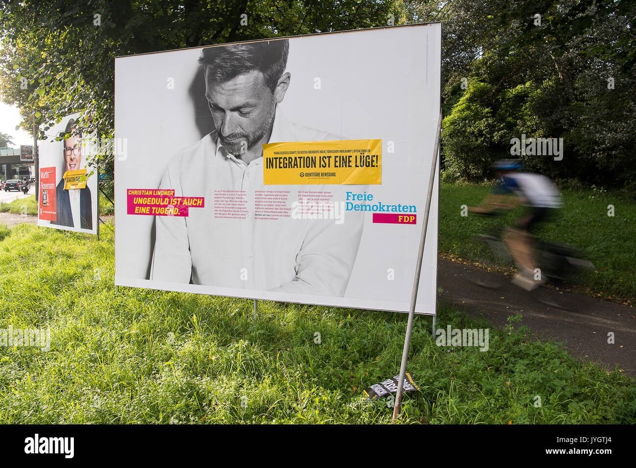 Right-wing stickers are pasted on an election posters of the German ...