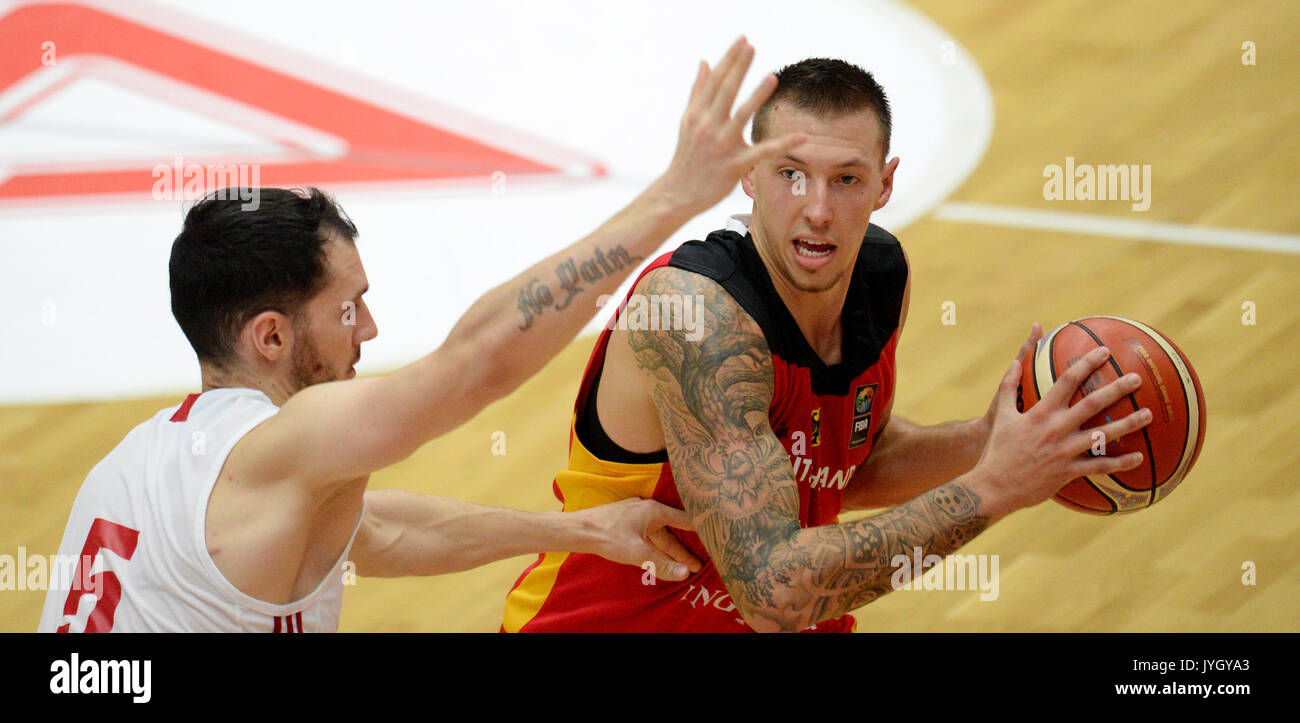 Germany's Daniel Theis (R) and Poland's Aaron Cel vie for the ball ...