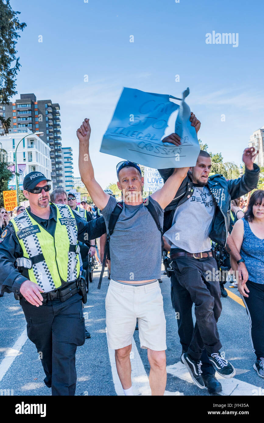 Angry man rips anti refugee sign from counter protester at Anti-Racism ...