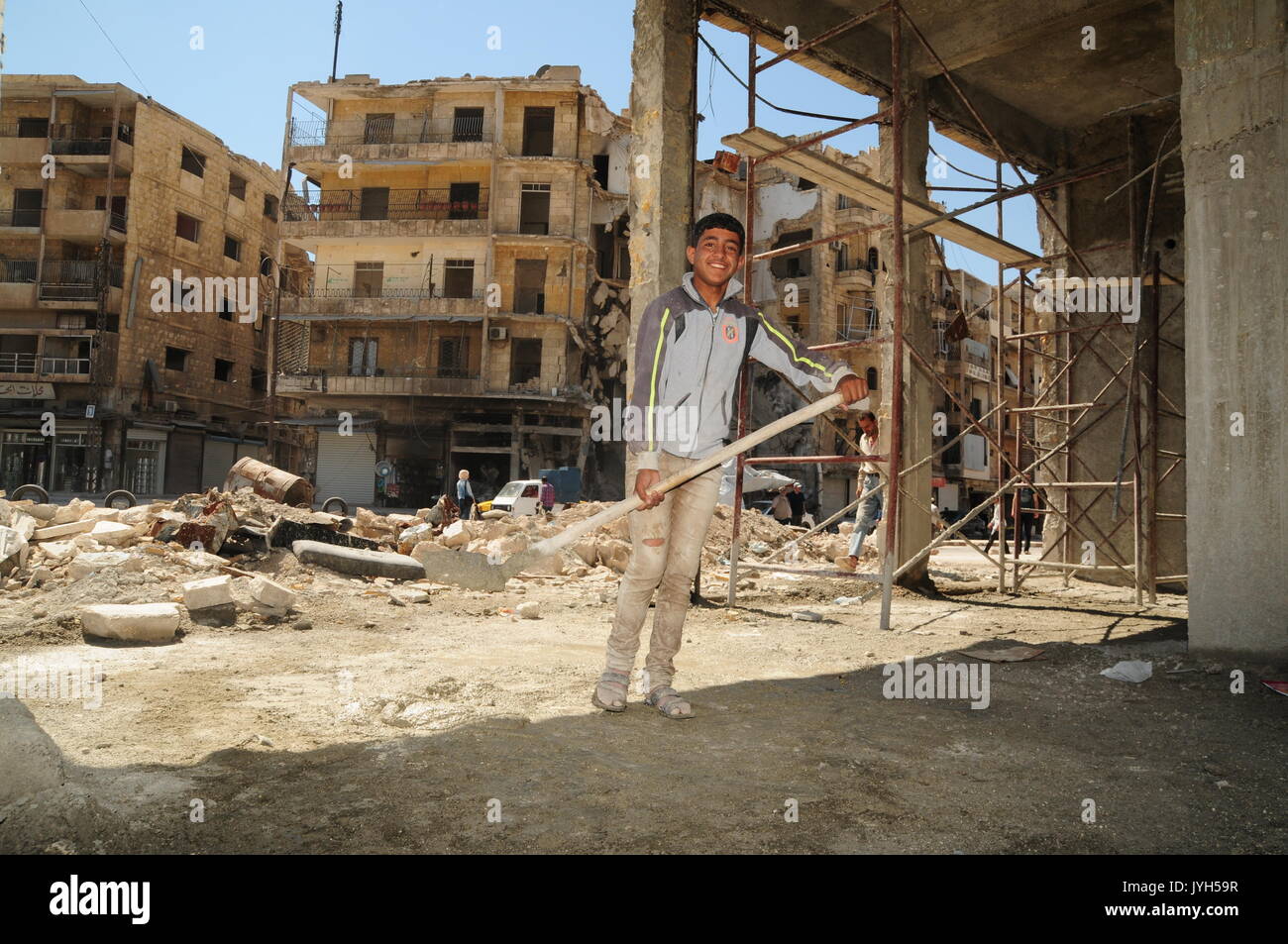 Aleppo, Syria. 24th June, 2017. A Syrian boy helping with a building's ...