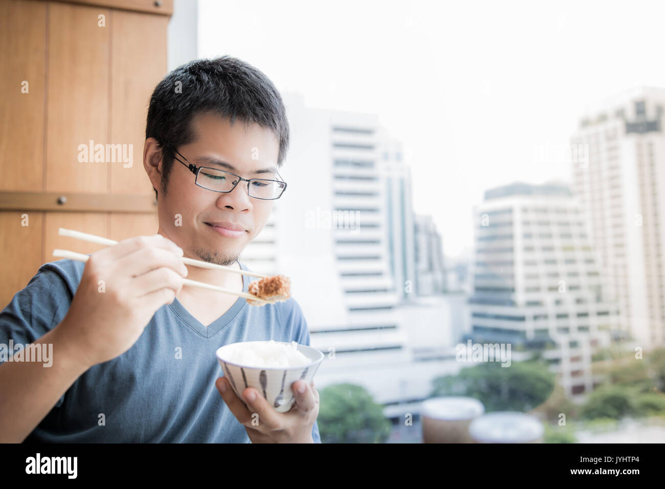 asian man eating lunch with hand holding chopstick Stock Photo - Alamy