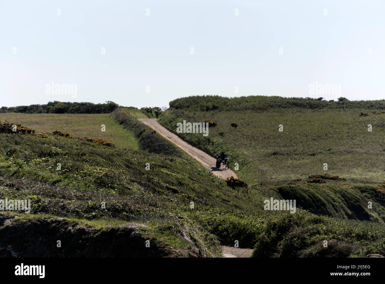 A lone horse drawn carriage makes its way up a hill on Little Sark on ...