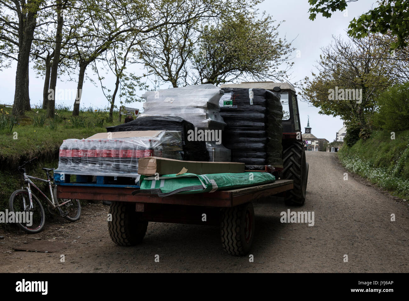 A tractor transporting imported building materials from the harbour up ...
