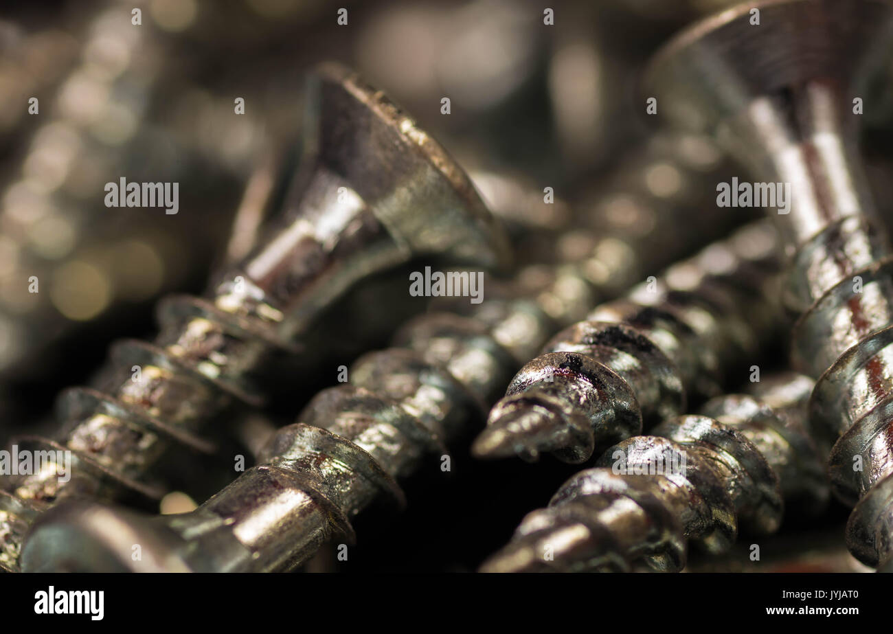 Screw threads in close where the threads are in focus at the front of ...