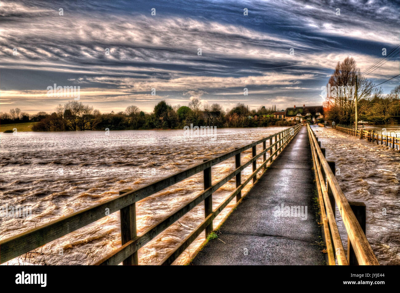 Pedestrian bridge over flooded fields beside the river Avon at ...