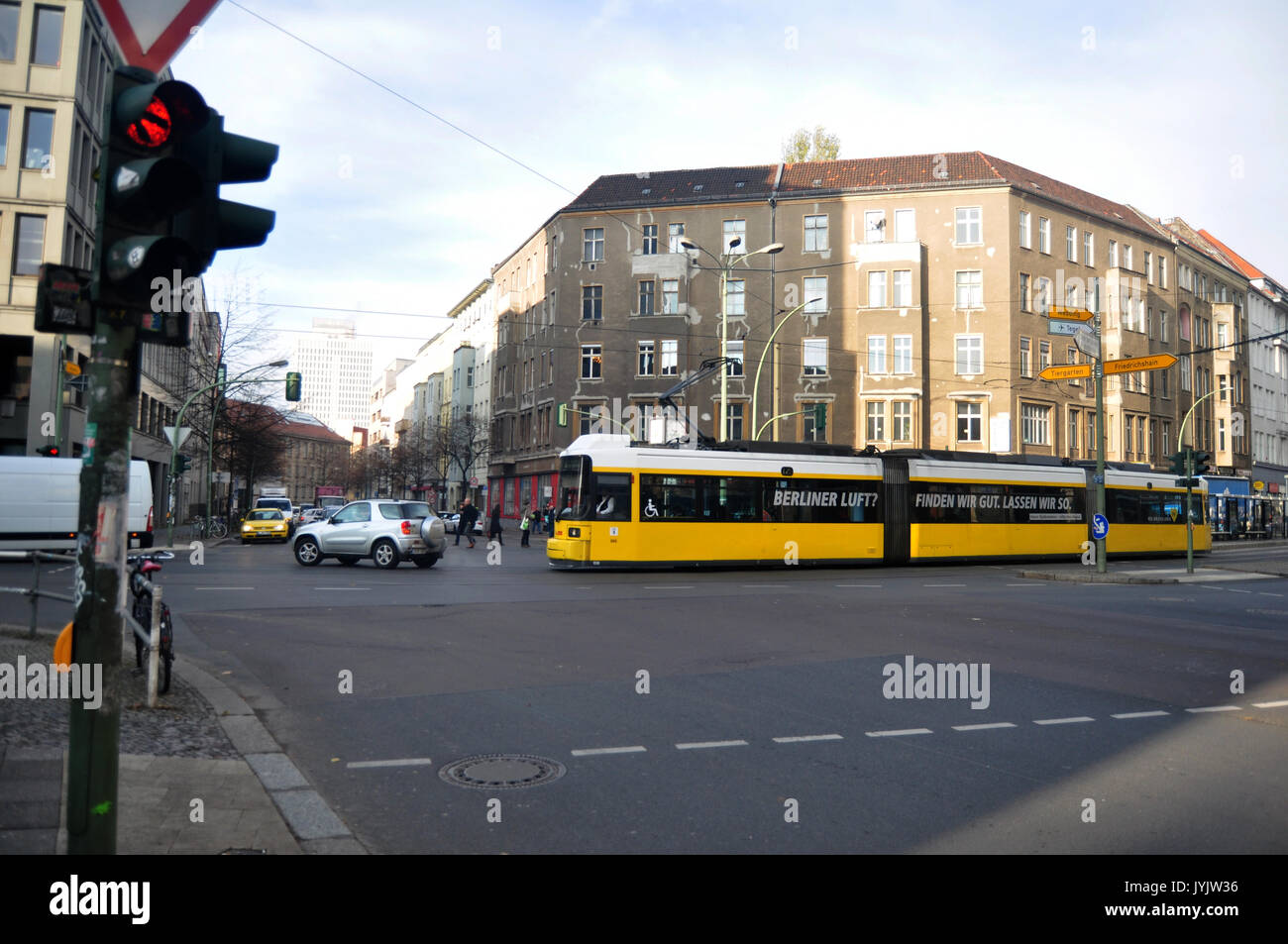 German people walking and drive car on the road with tramway networks ...