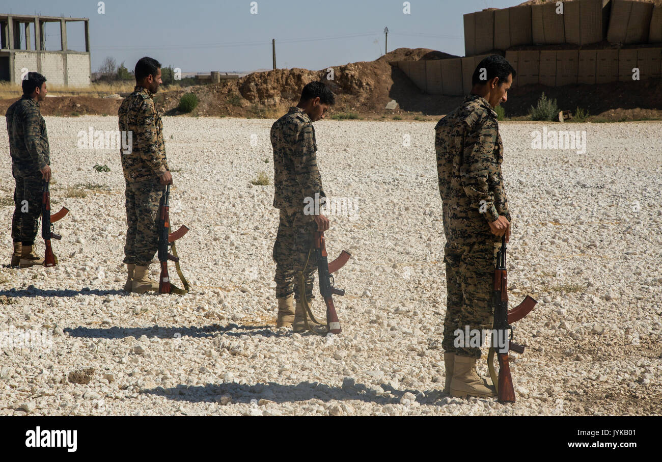 Syrian Arab trainees await commands from an instructor at a Syrian ...