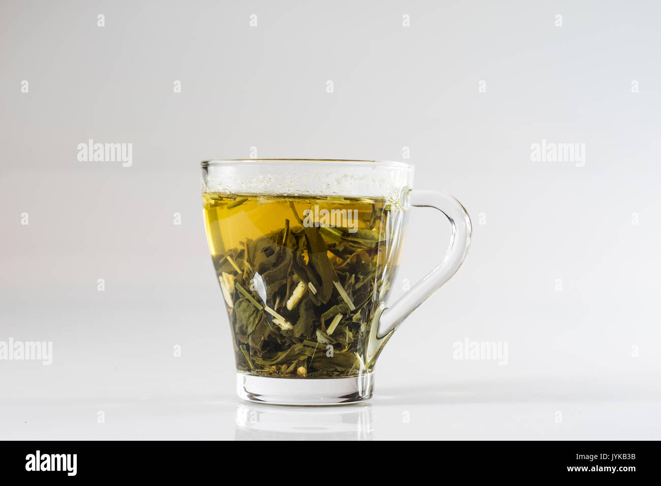 Tea in a glass on a white background. Green or fruit tea. Glass of ...
