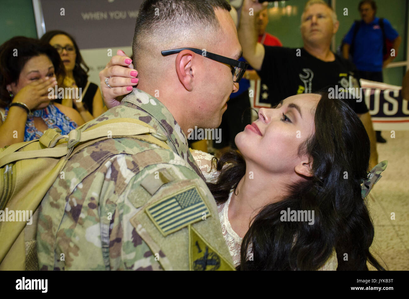 Spc. Gary Maestas is greeted with a tender hug from his wife upon the ...