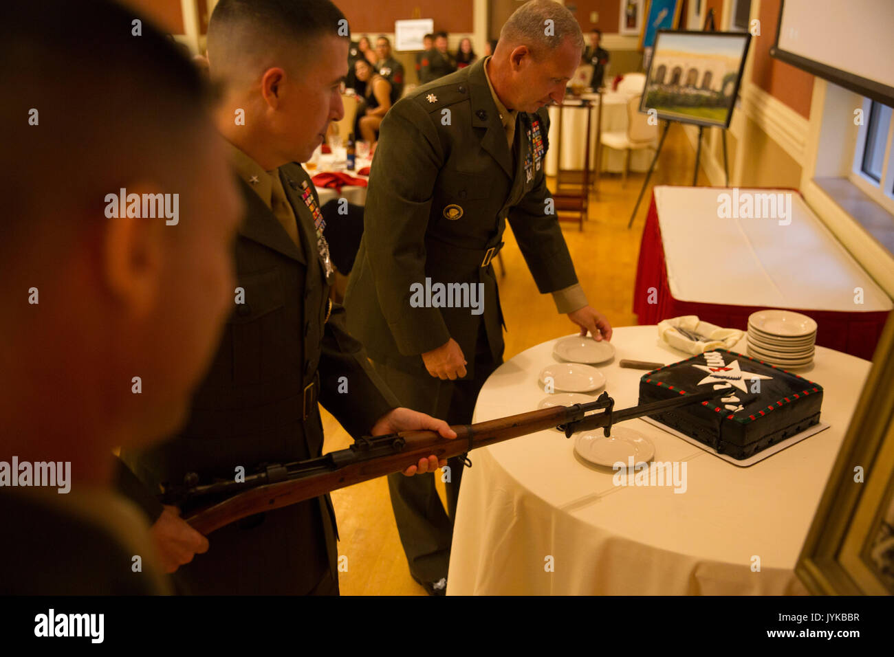 Brig. Gen. Benjamin Watson cuts the ceremony’s cake with a bayonet ...