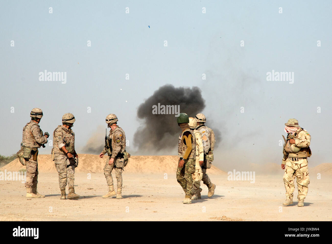 Spanish army trainers and Iraqi security forces turn to watch a charge ...