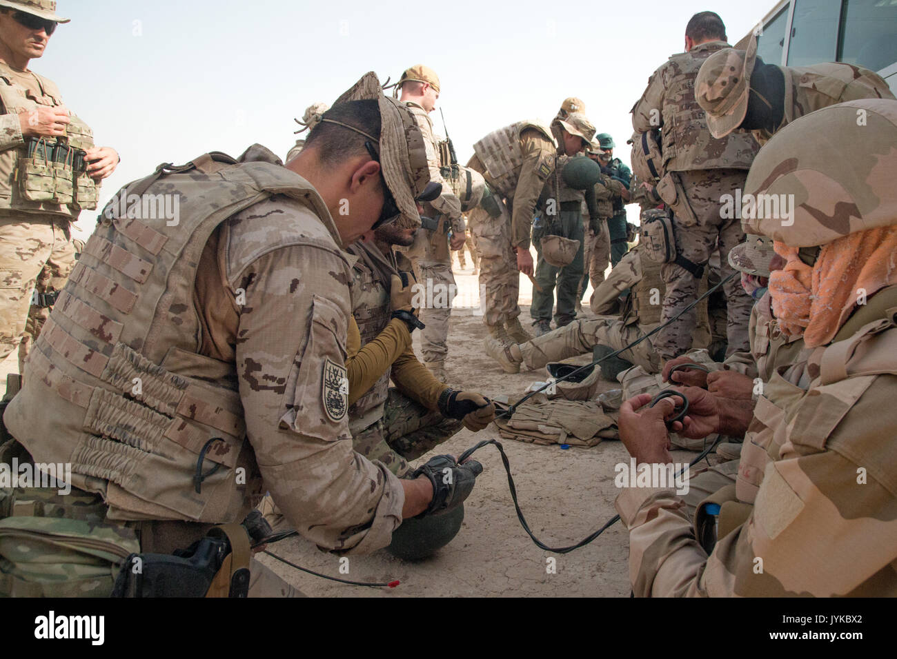 A Spanish army trainer assists Iraqi security forces members during ...
