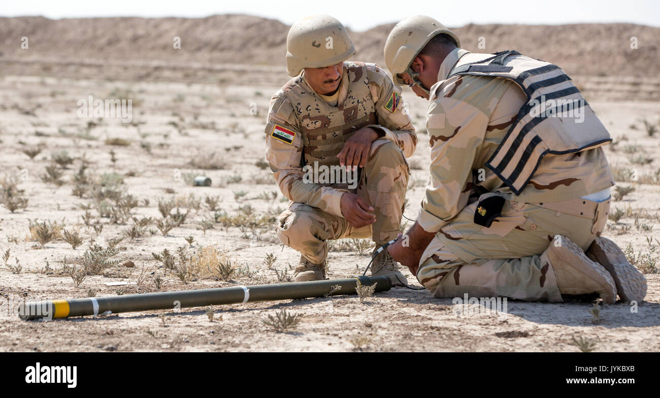 An Iraqi security forces member prepares a Bangalore torpedo during ...