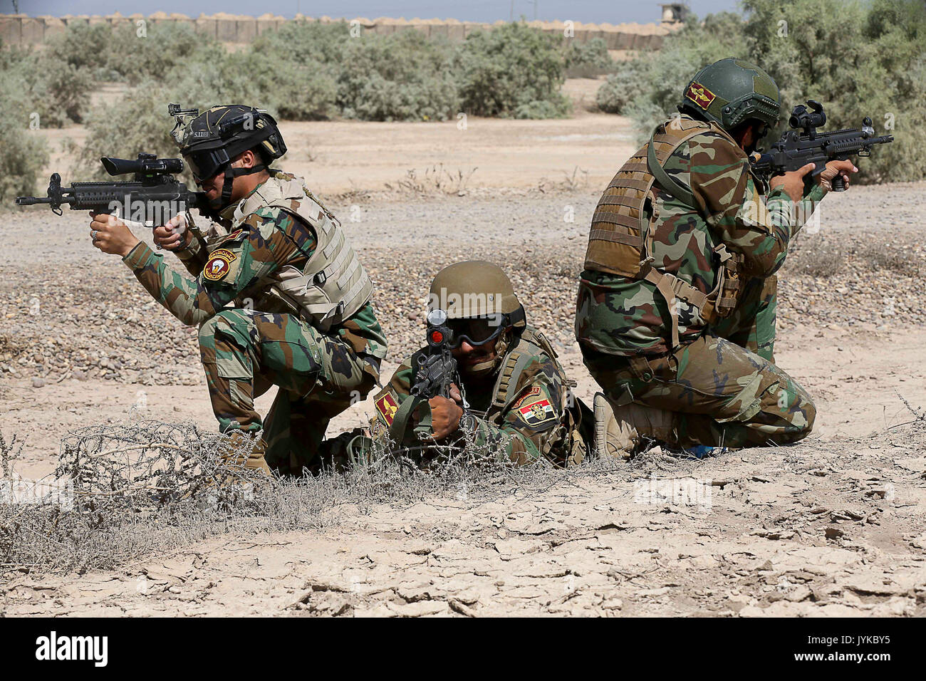 Iraqi army rangers aim down the sights of their weapon systems during ...