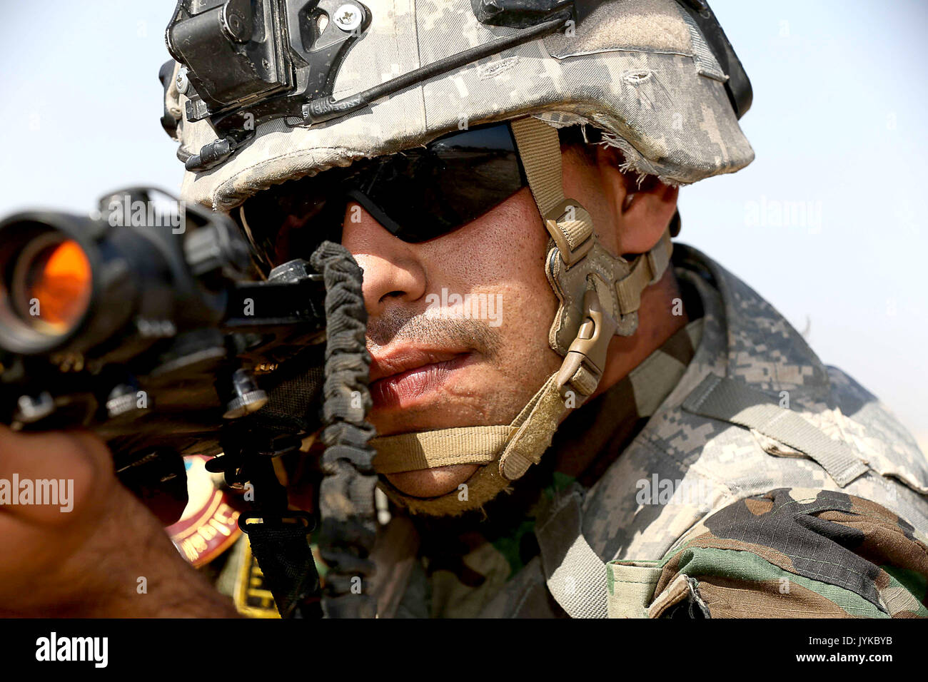 An Iraqi army ranger aims down the sights of his weapon system during ...