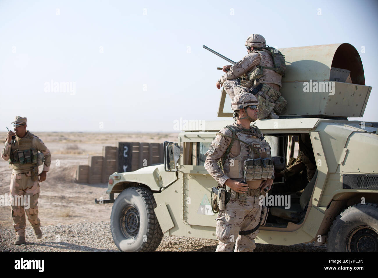 A Spanish army trainer watches Iraqi security forces maneuver during ...