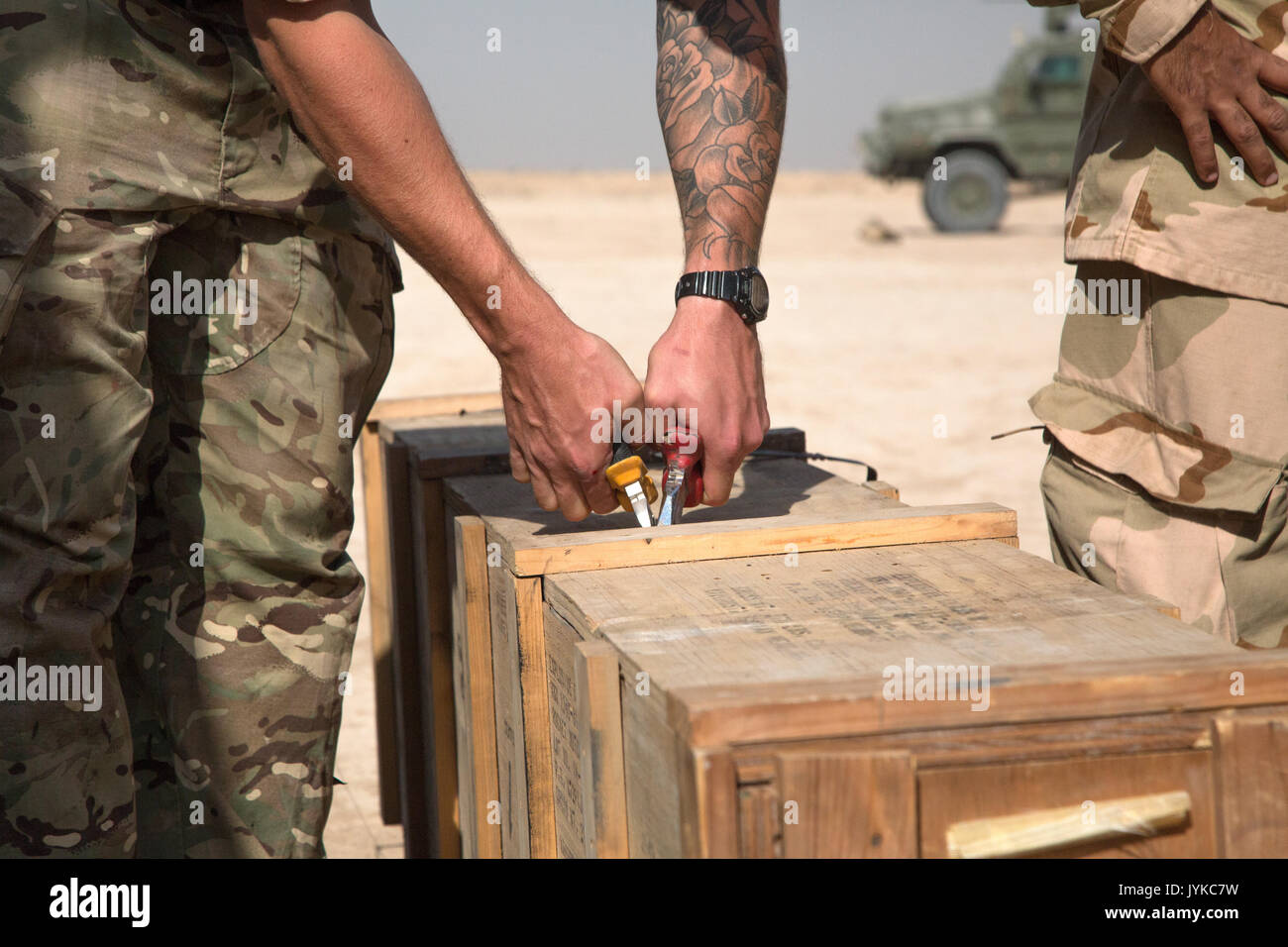 A British army trainer opens a box in preparation for Mine Clearing ...