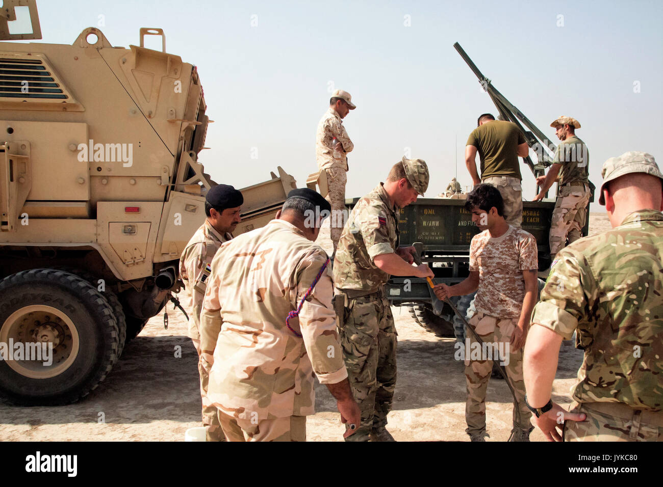 A British army trainer assists an Iraqi security forces member during ...
