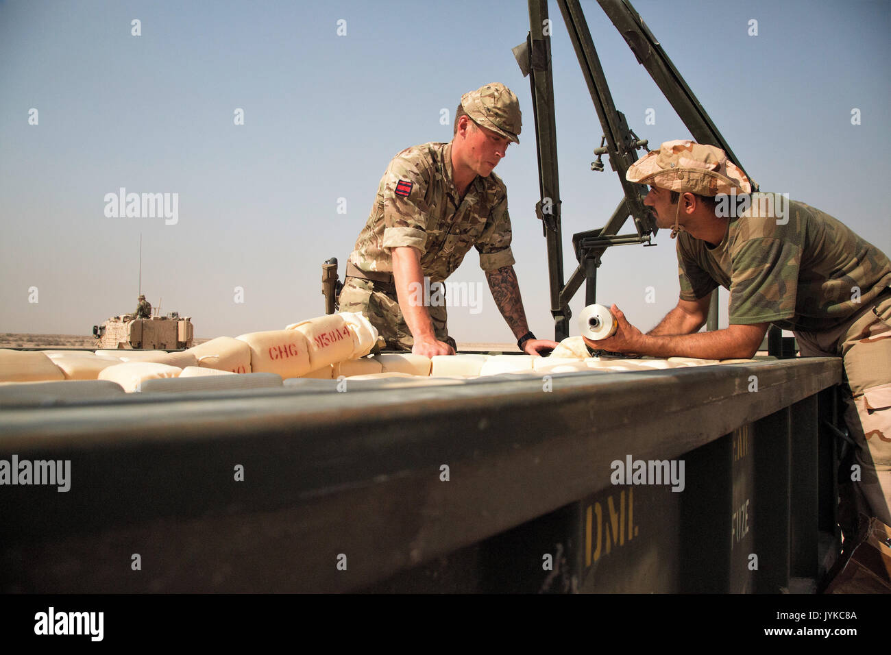 A British army trainer assists an Iraqi security forces member during ...