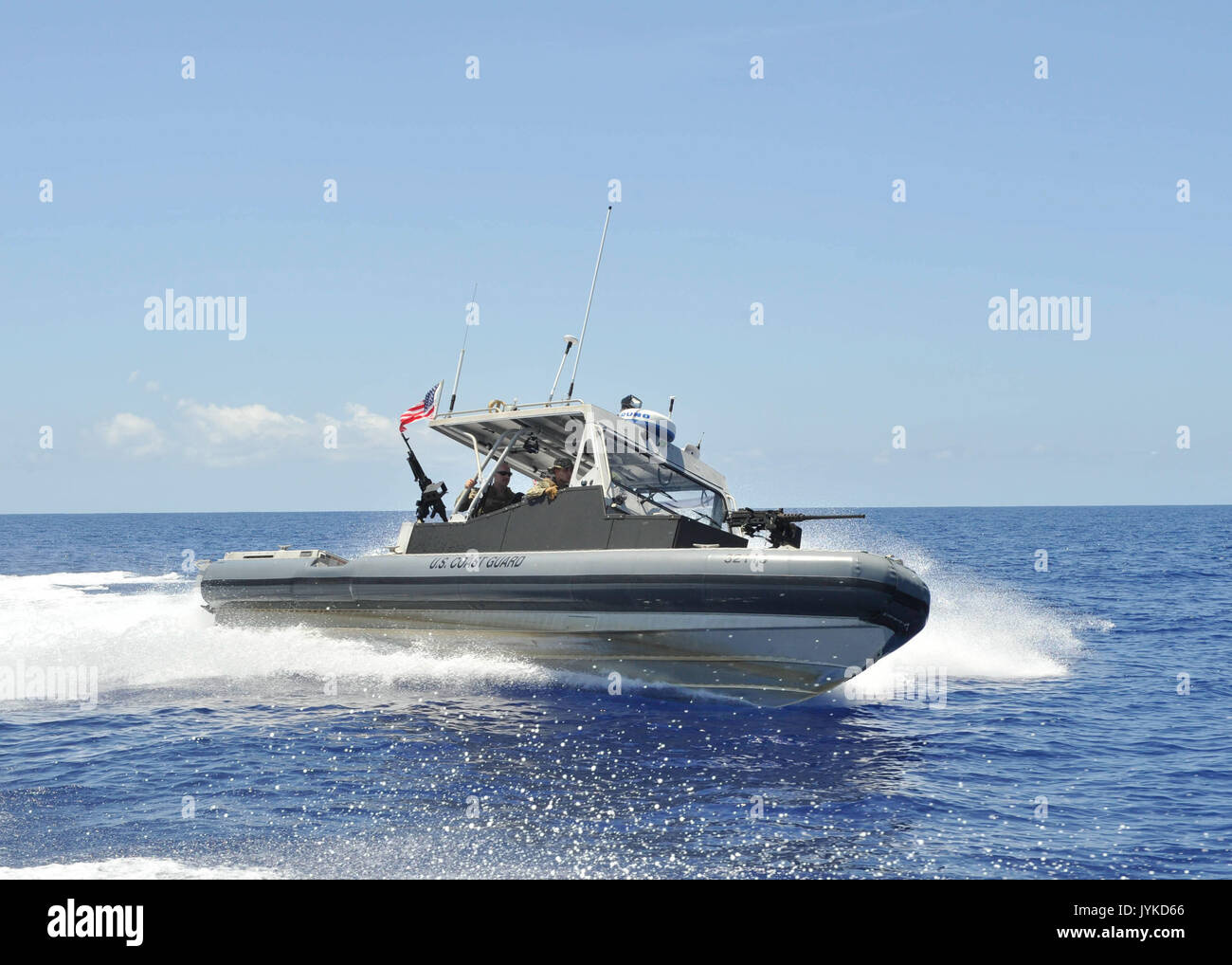 Coast Guardsmen from Port Security Unit 305 aboard a 32-foot ...