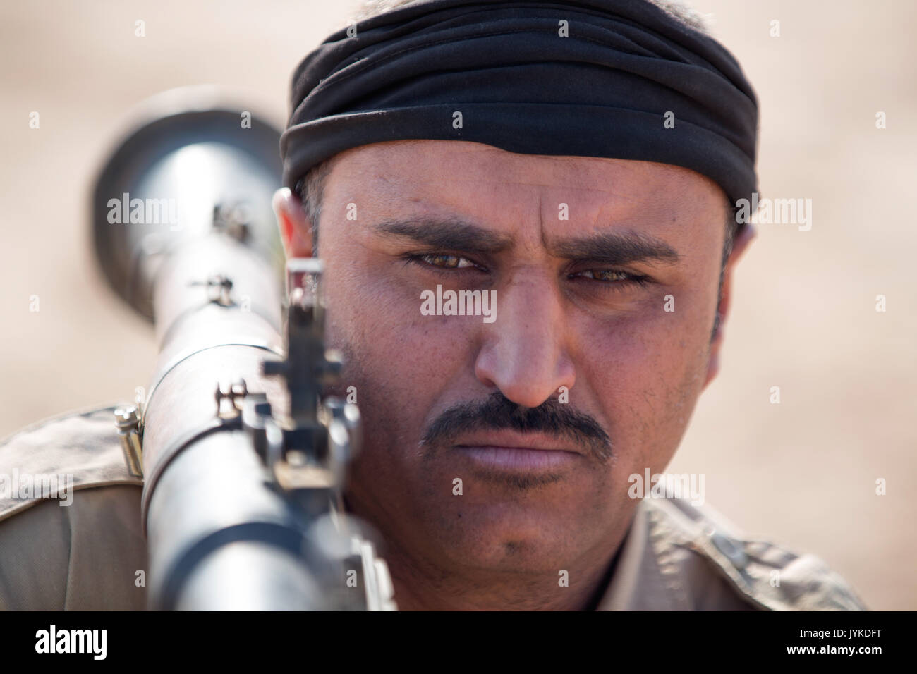 An Iraqi security forces member prepares for an approaching vehicle by ...