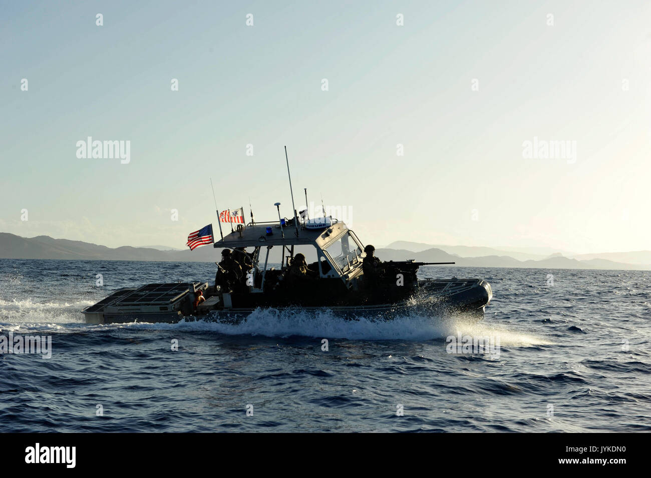 Coast Guardsmen from Port Security Unit 305 aboard a 32-foot ...
