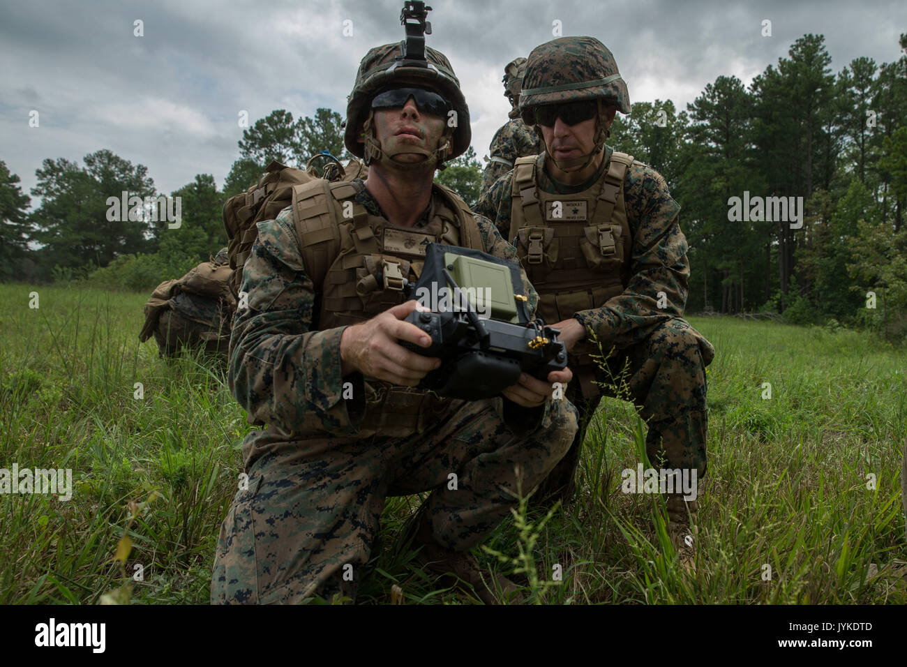 U.S. Marine Corps Lance Cpl. Ryan Skinner (center), assistant patrol ...