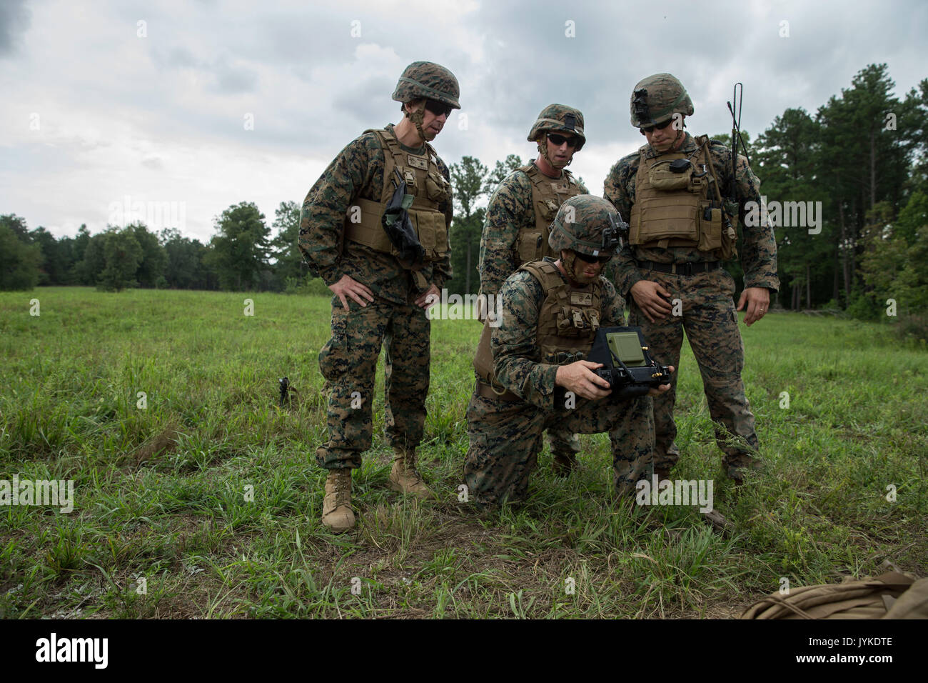 U.S. Marine Corps Lance Cpl. Ryan Skinner (center), assistant patrol ...