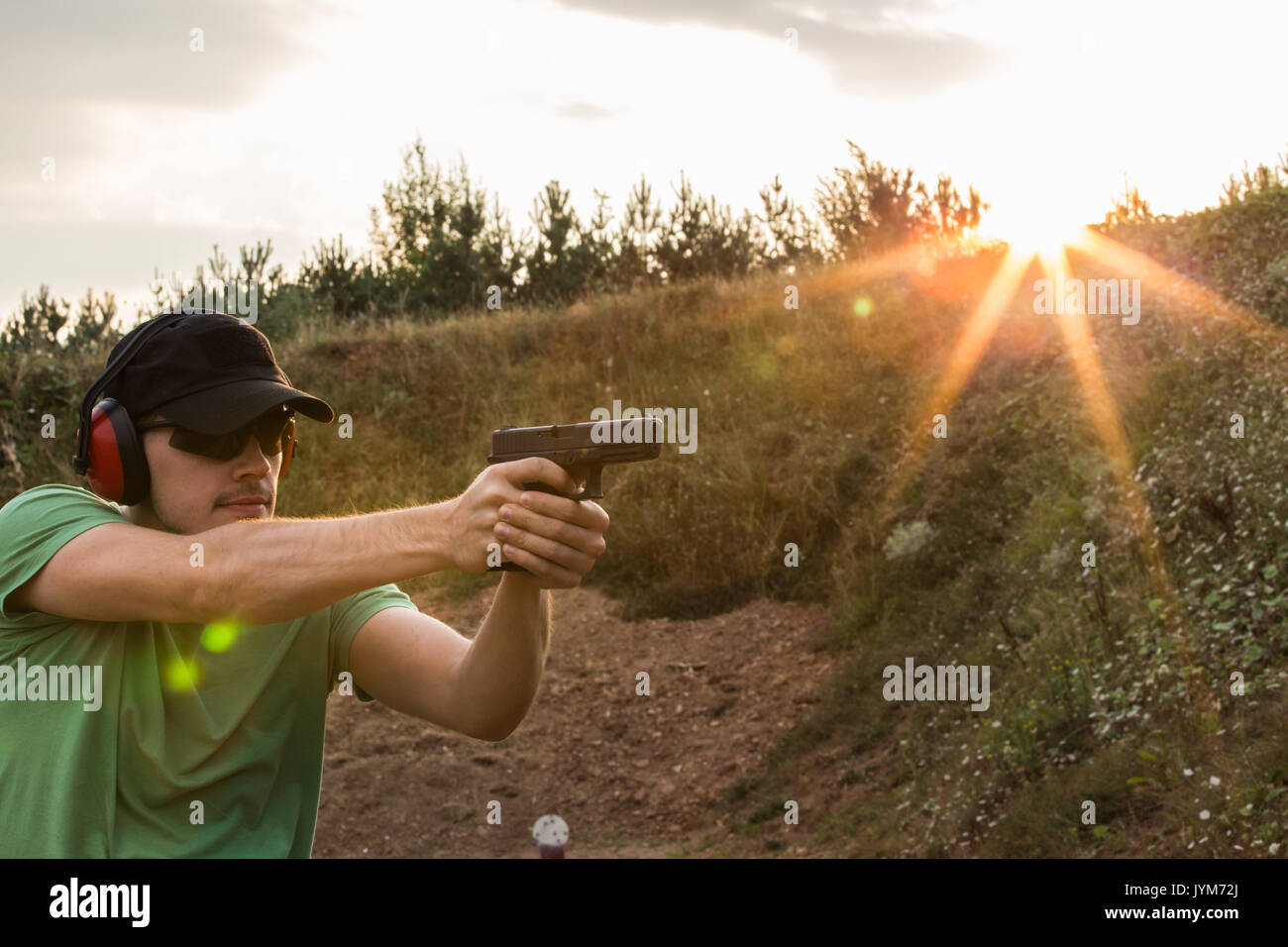 Training outside to shoot with gun glock pistol for military handsome ...