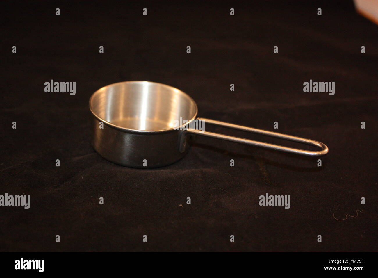Stainless steel measuring spoon Stock Photo - Alamy