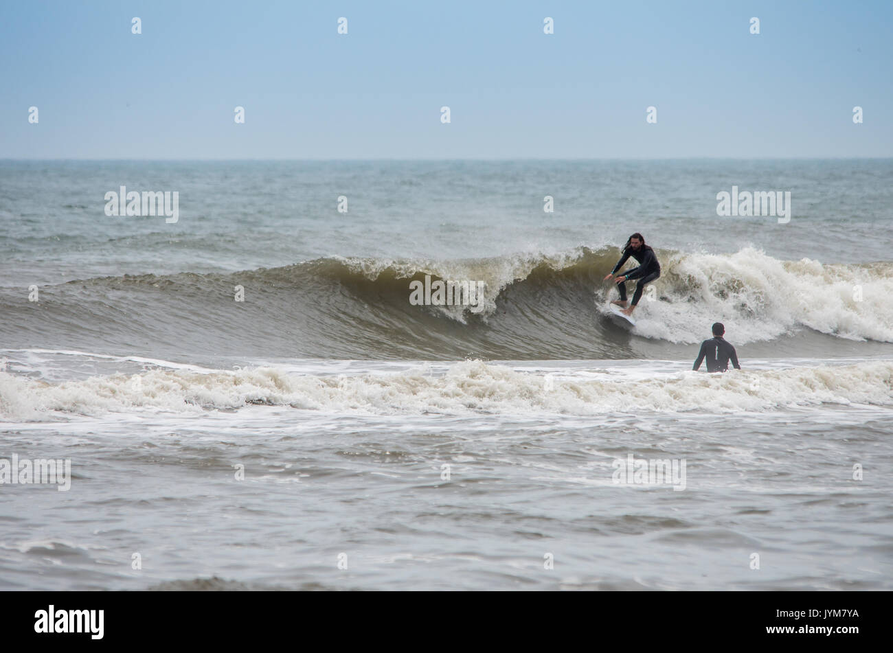 Two surfers riding a wave in the outer banks North Carolina Stock Photo ...