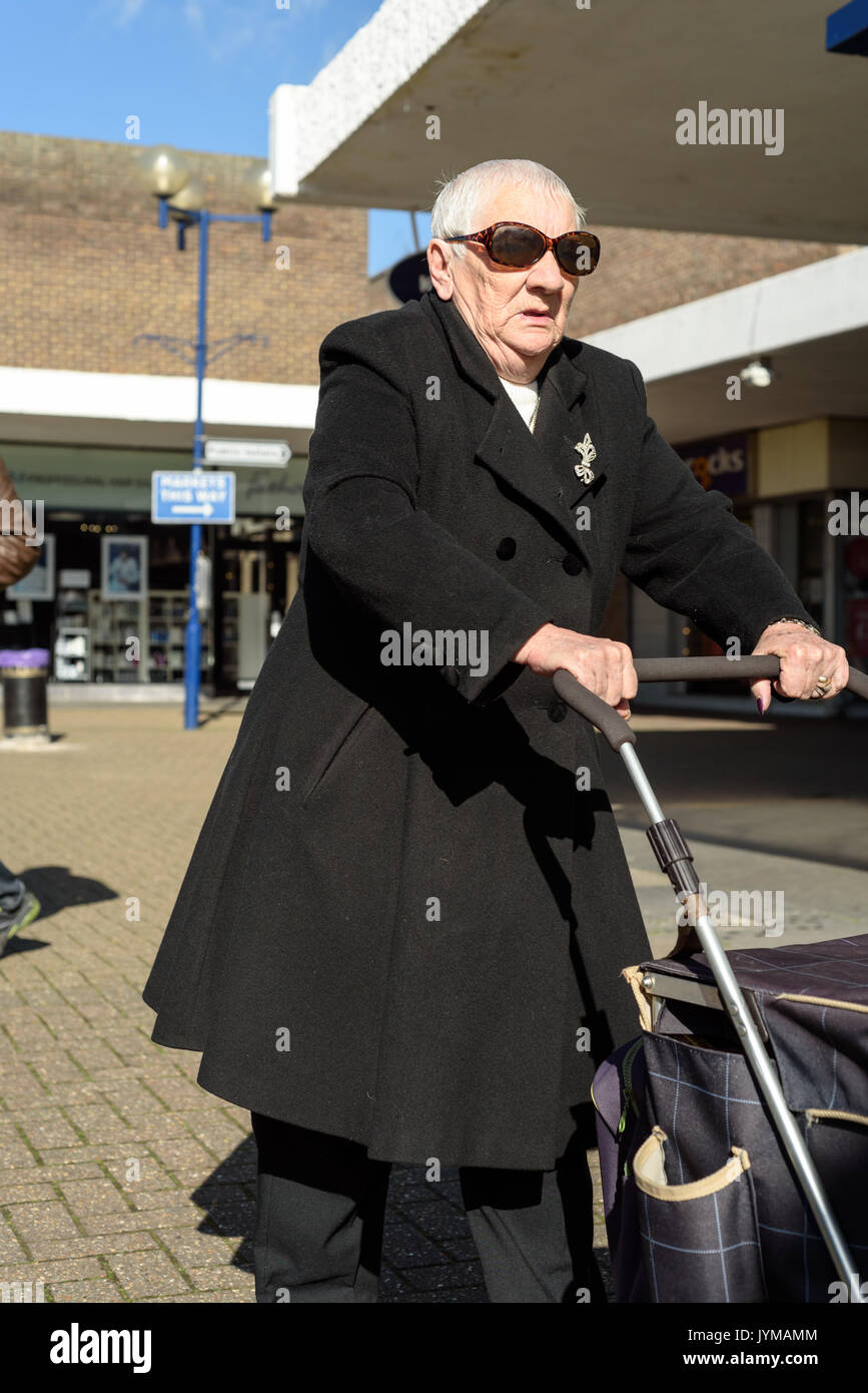 Old woman pushing shopping trolley hi-res stock photography and images ...