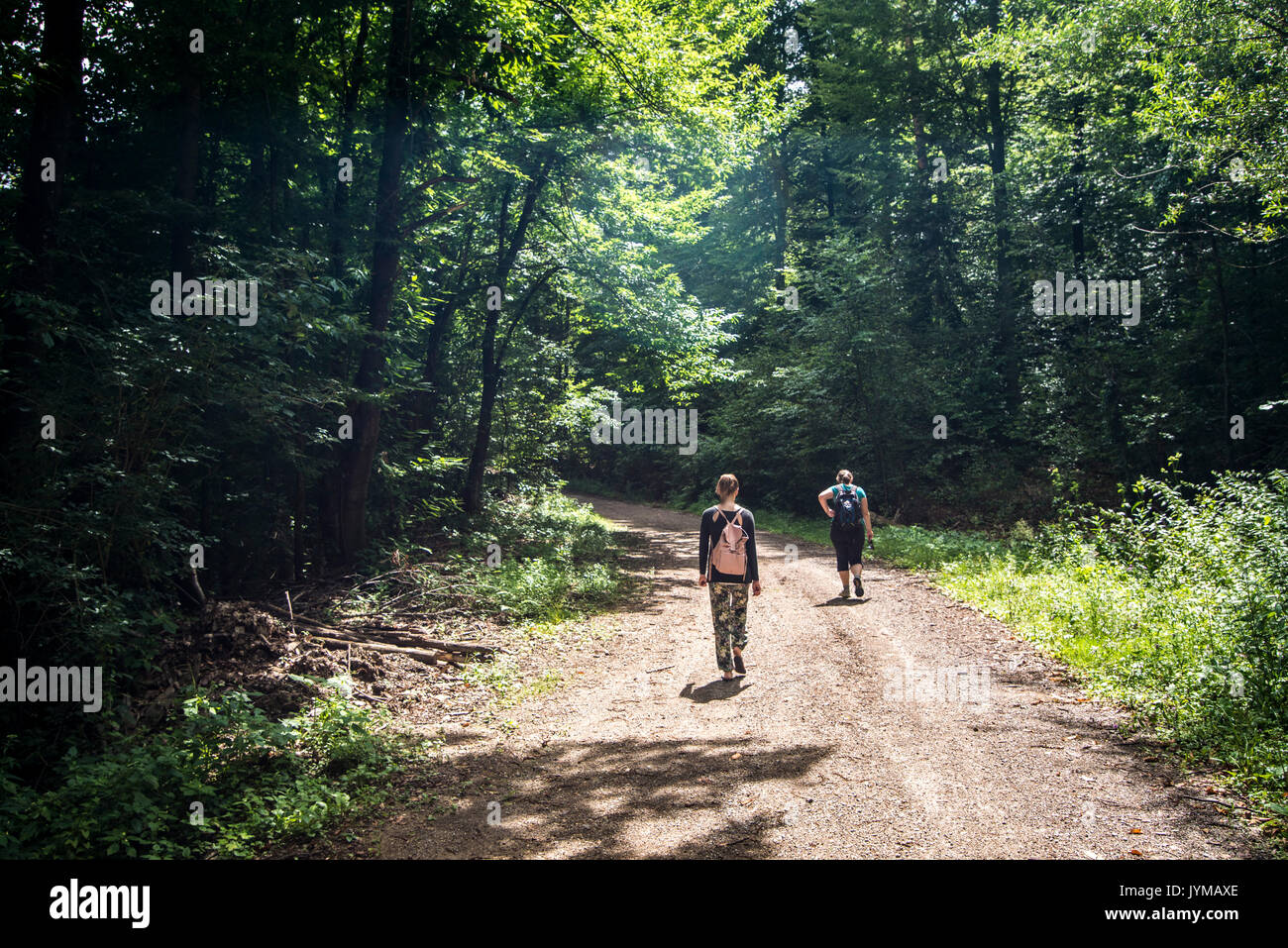 Woman walking on grass pathway hi-res stock photography and images - Alamy