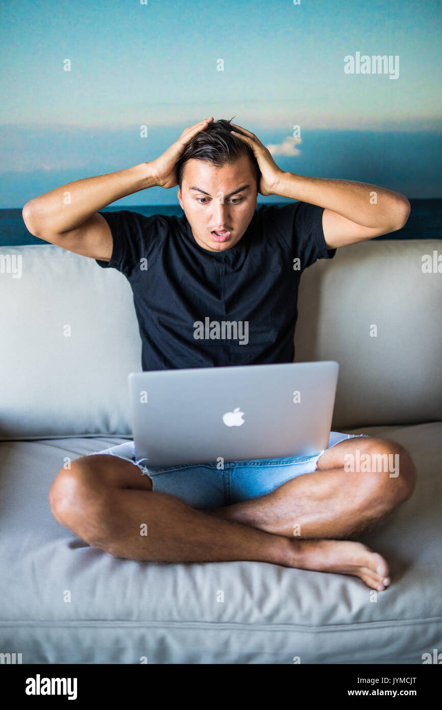 Shocked Surprised Man Looking At Laptop Computer Surprised And Amazed