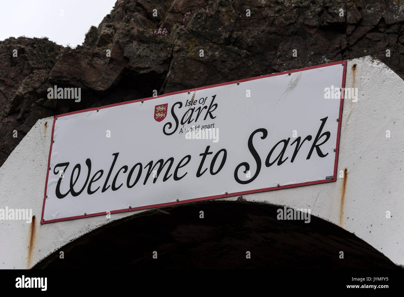 Arriving visitors are greeted with a sign above a short tunnel ...