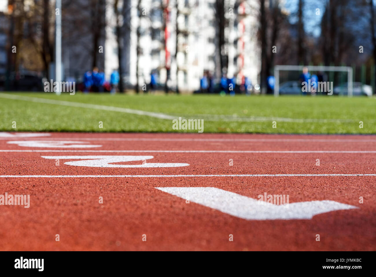 Red running track closeup in stadium, Blurred soccer or football ...