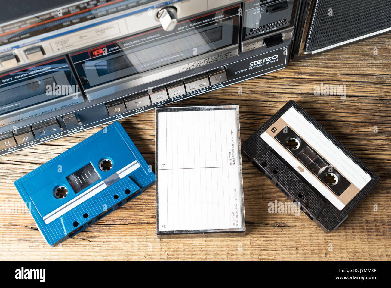 compact cassette tapes and cassette player ghettoblaster on wooden ...