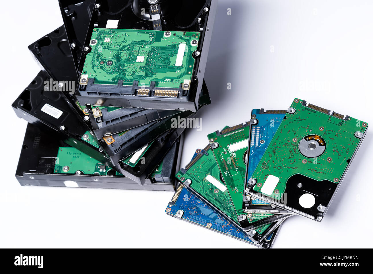 pile of old hard drives at white background Stock Photo - Alamy
