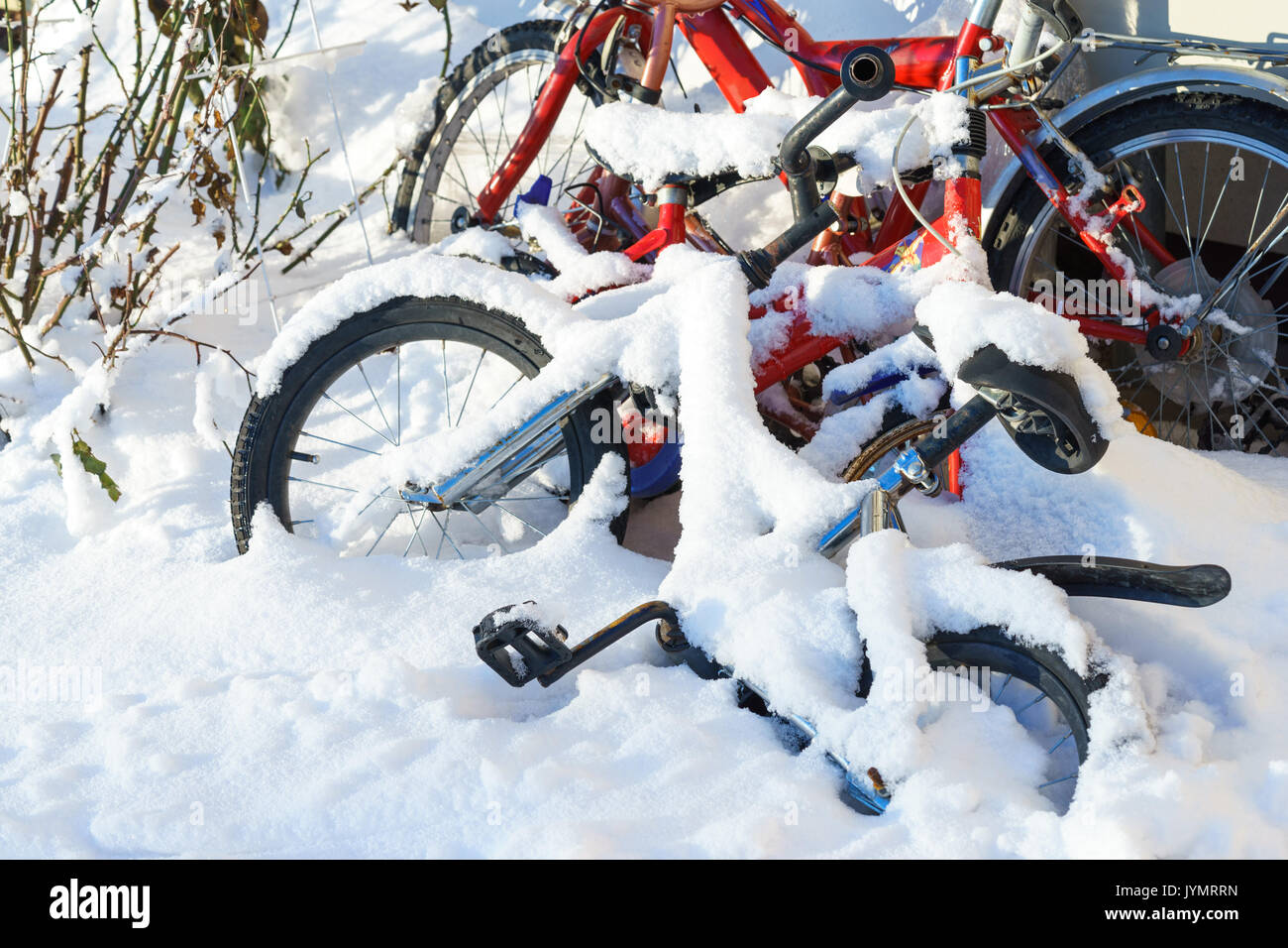 Bike Covered with Fresh Snow. Kids bikes Covered with Winter Snow. The ...