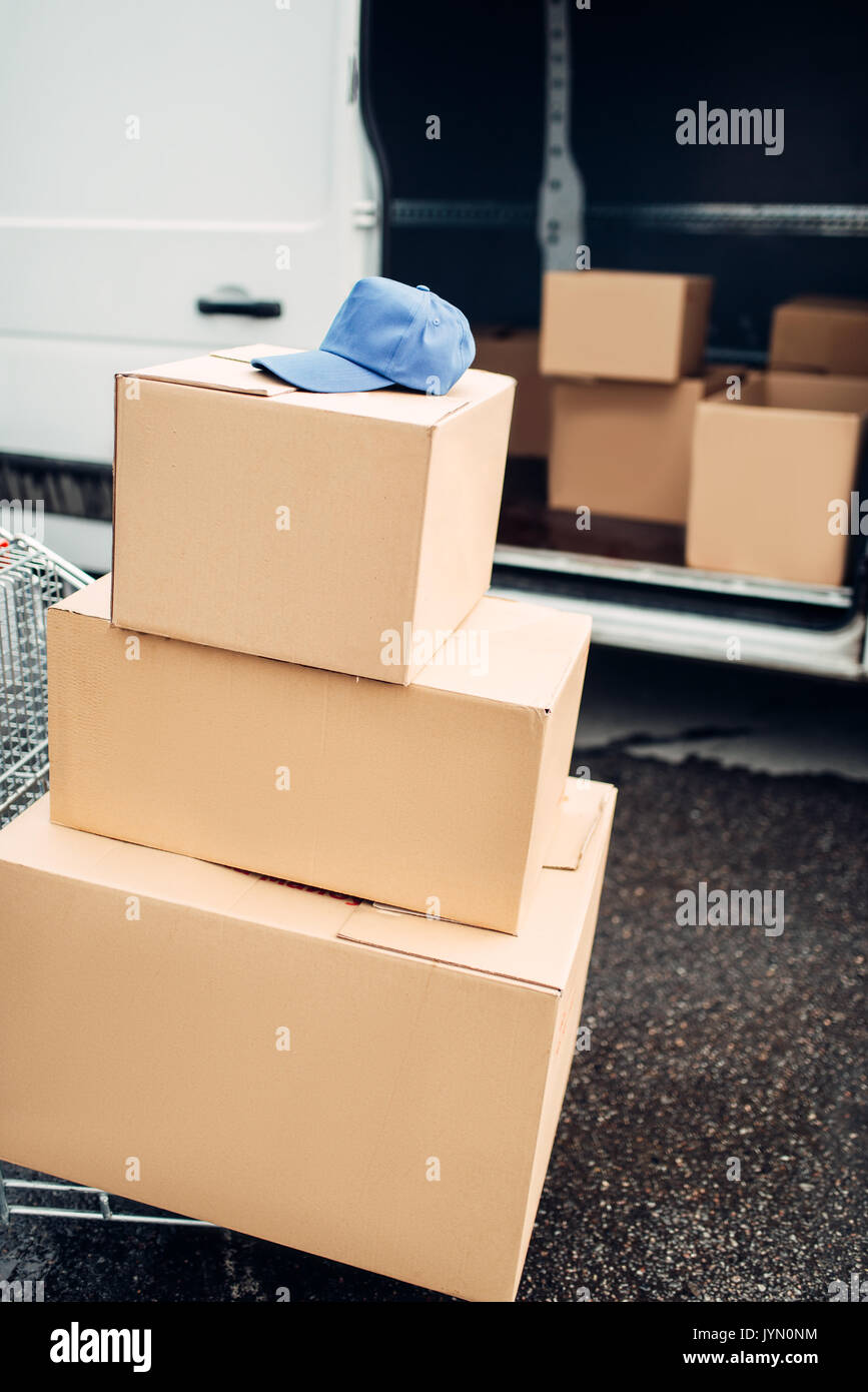 Trolley with carton boxes against truck . Distribution business. Cargo ...