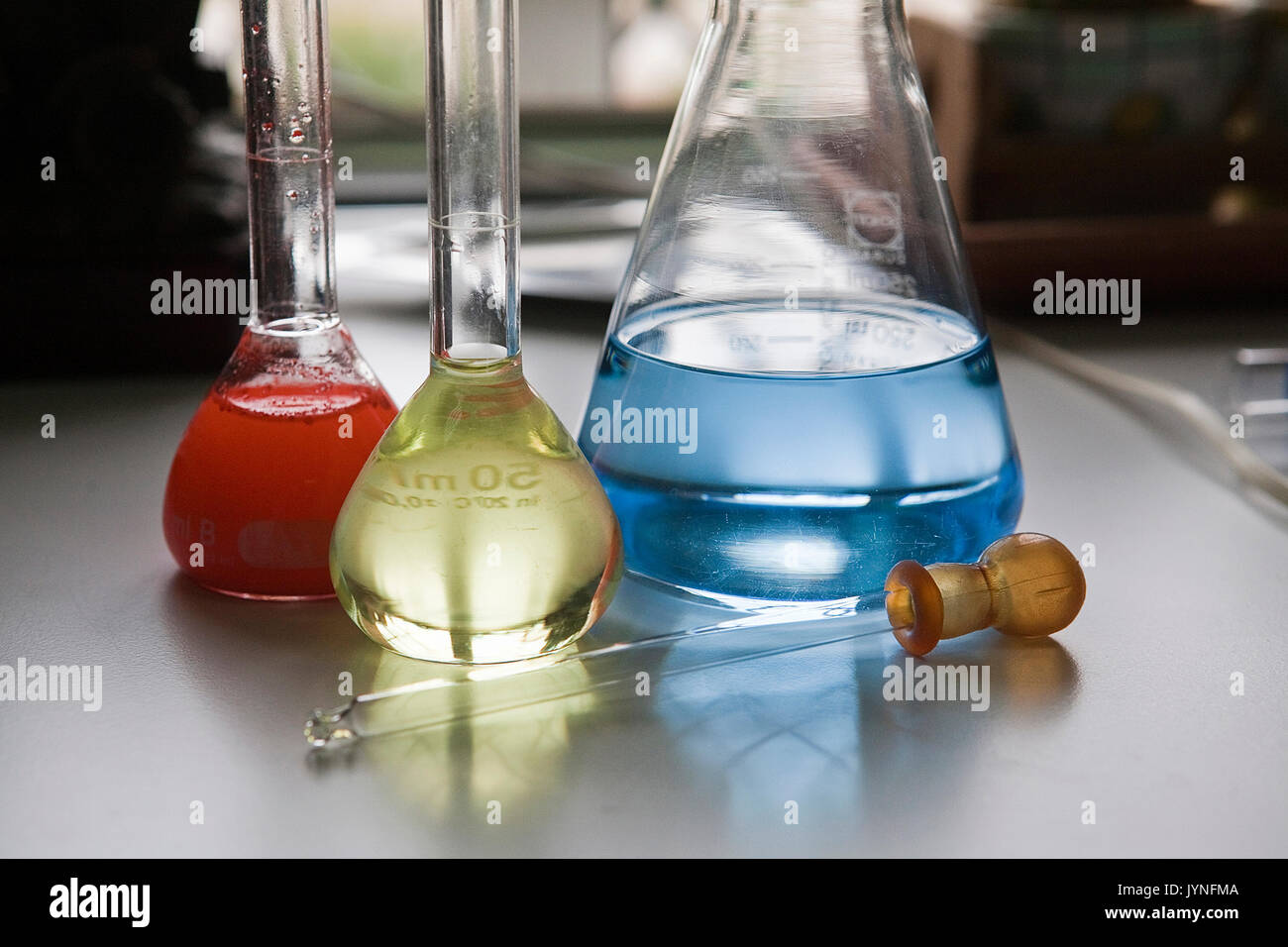 chemical laboratory flasks containing liquid shiny Stock Photo - Alamy