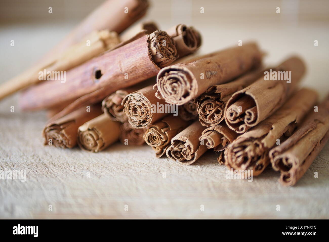 Dried, rolled true cinnamon (Cinnamomum verum) sticks in a pile on a ...
