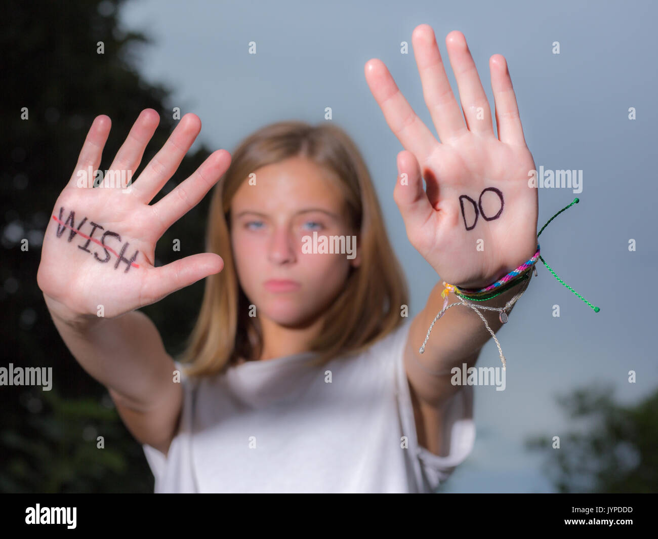 Teenage Girl hold up hands with motivational quotes written on palms ...