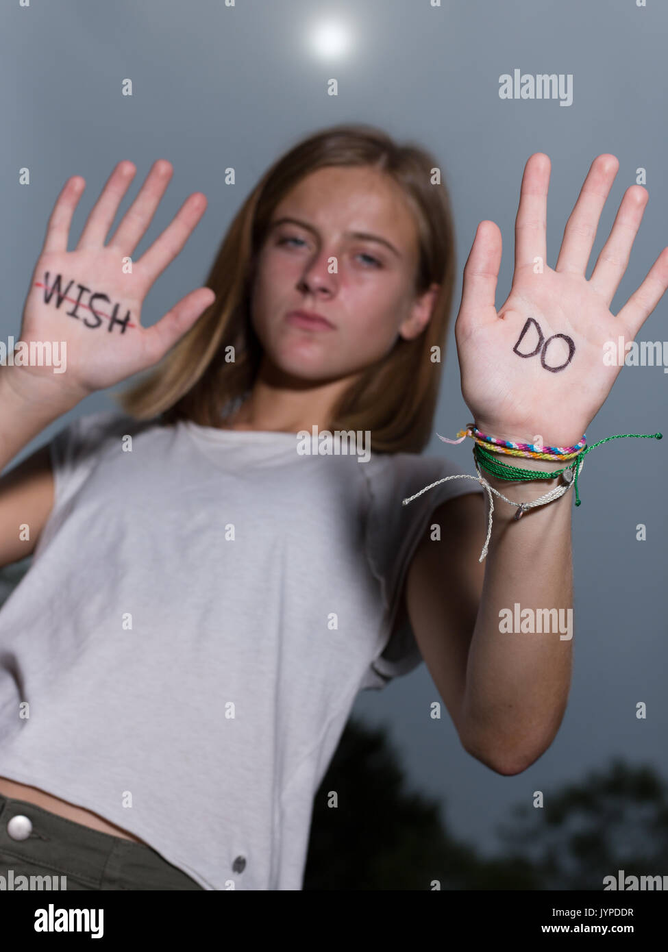 Teenage Girl hold up hands with motivational quotes written on palms ...