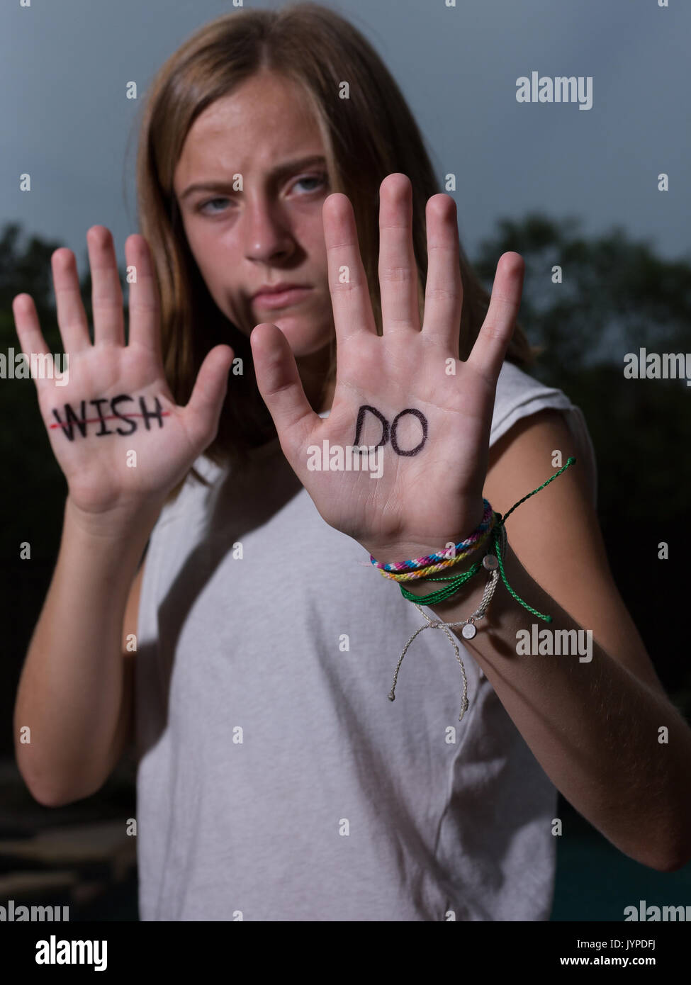 Teenage Girl hold up hands with motivational quotes written on palms ...