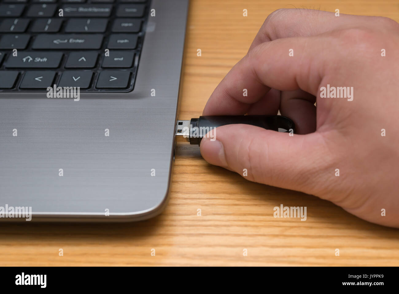 hand putting a USB flash drive to a laptop Stock Photo - Alamy