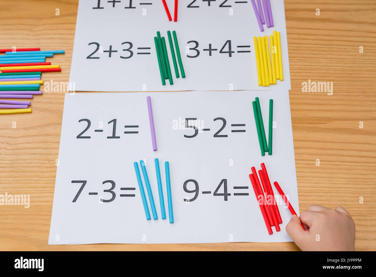 kid learning simple subtraction and addition by counting numbers of ...