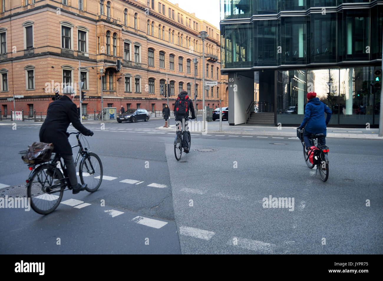 German people walking and biking bicycle on the road with classical ...
