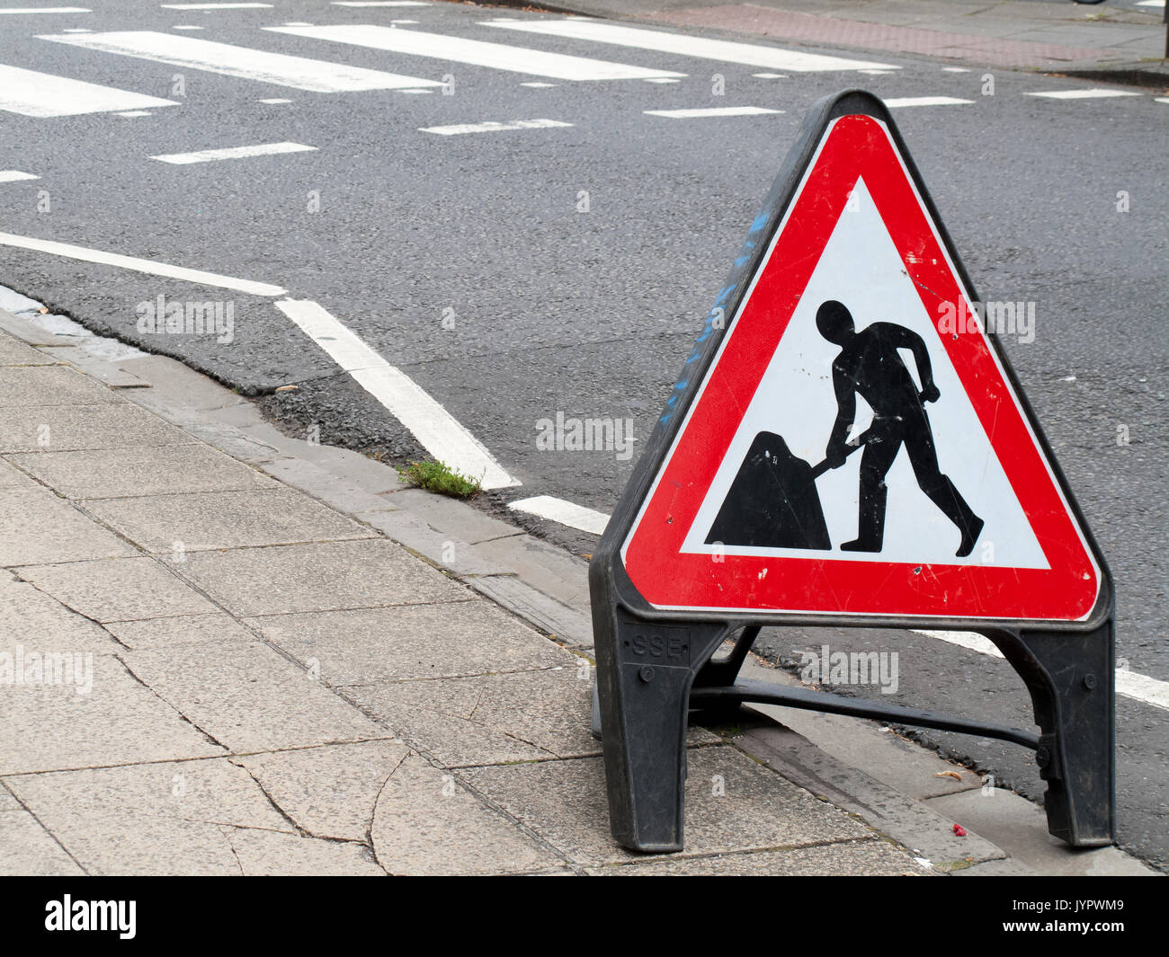 Highway roadworks sign on approach to zebra crossing Stock Photo - Alamy