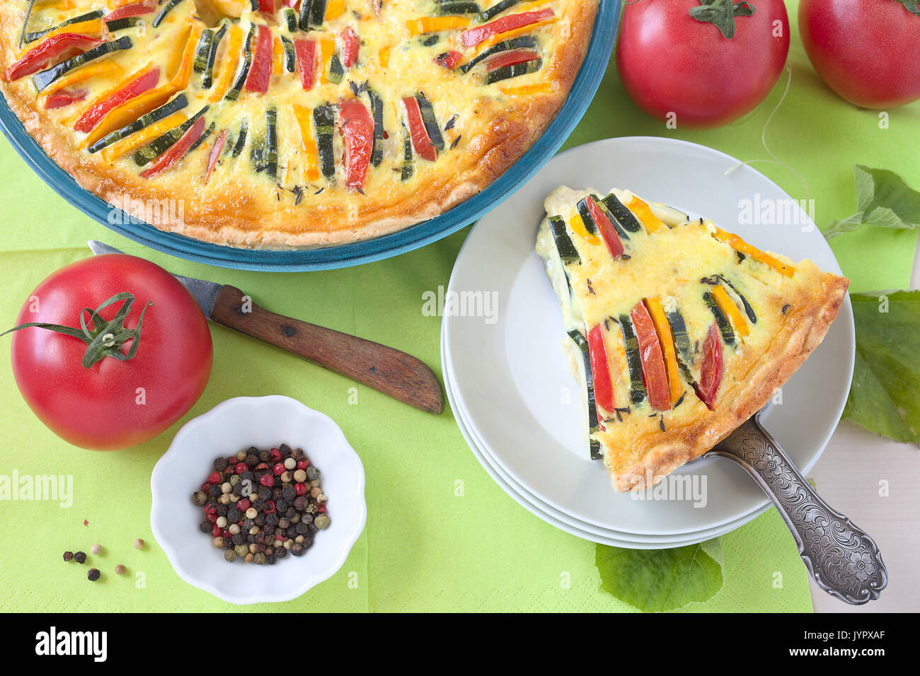 Quiche with tomato, green and yellow zucchini Stock Photo - Alamy